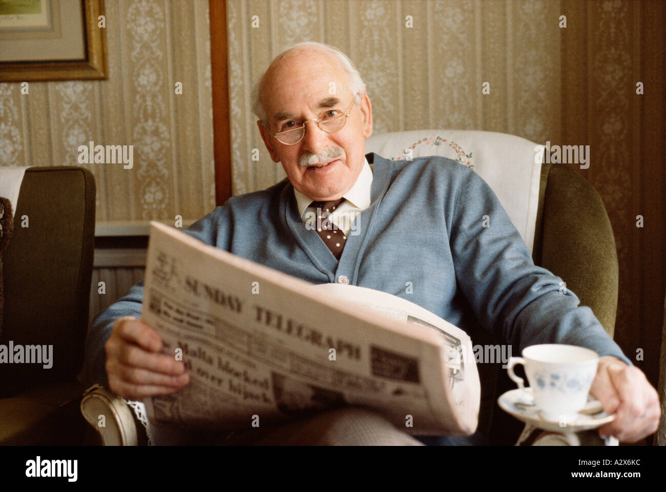 Old English man sitting in armchair. With Sunday Telegraph newspaper ...