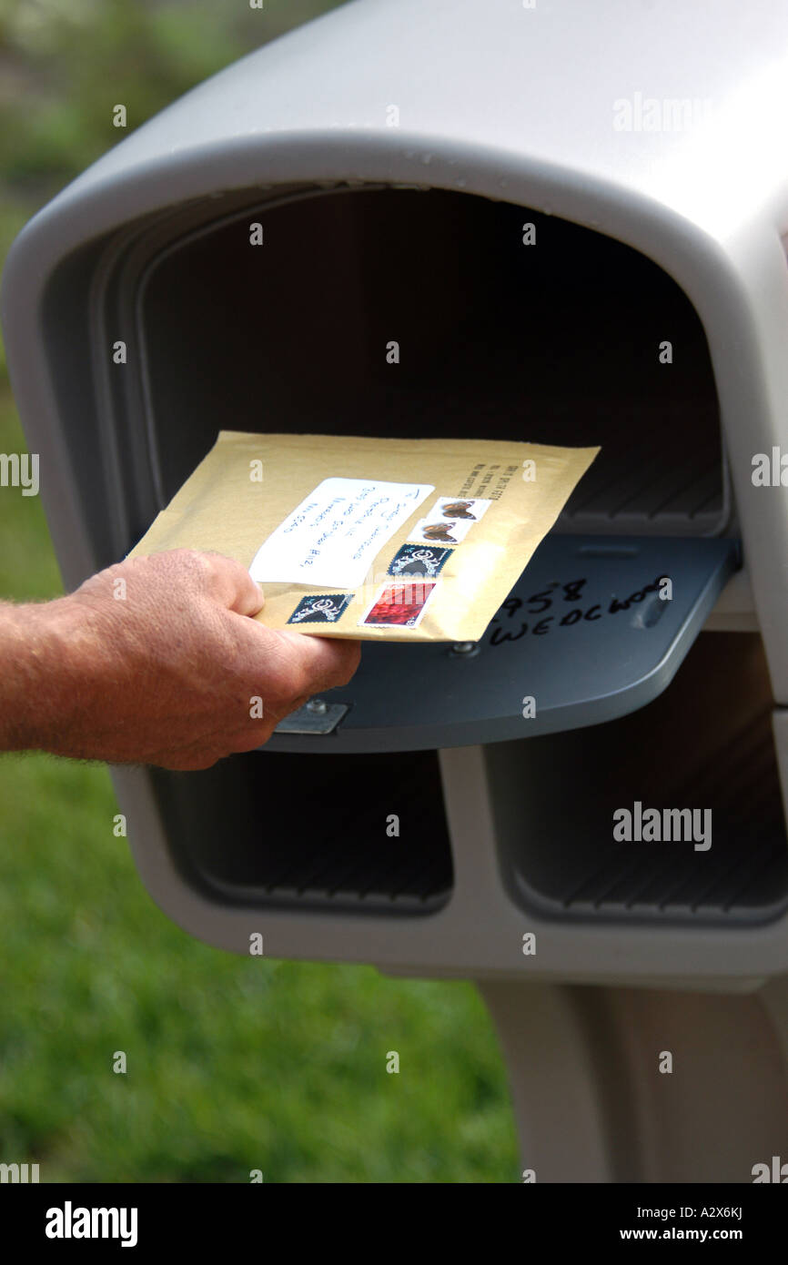 Placing a letter in the mail box for collection by the US Postal ...