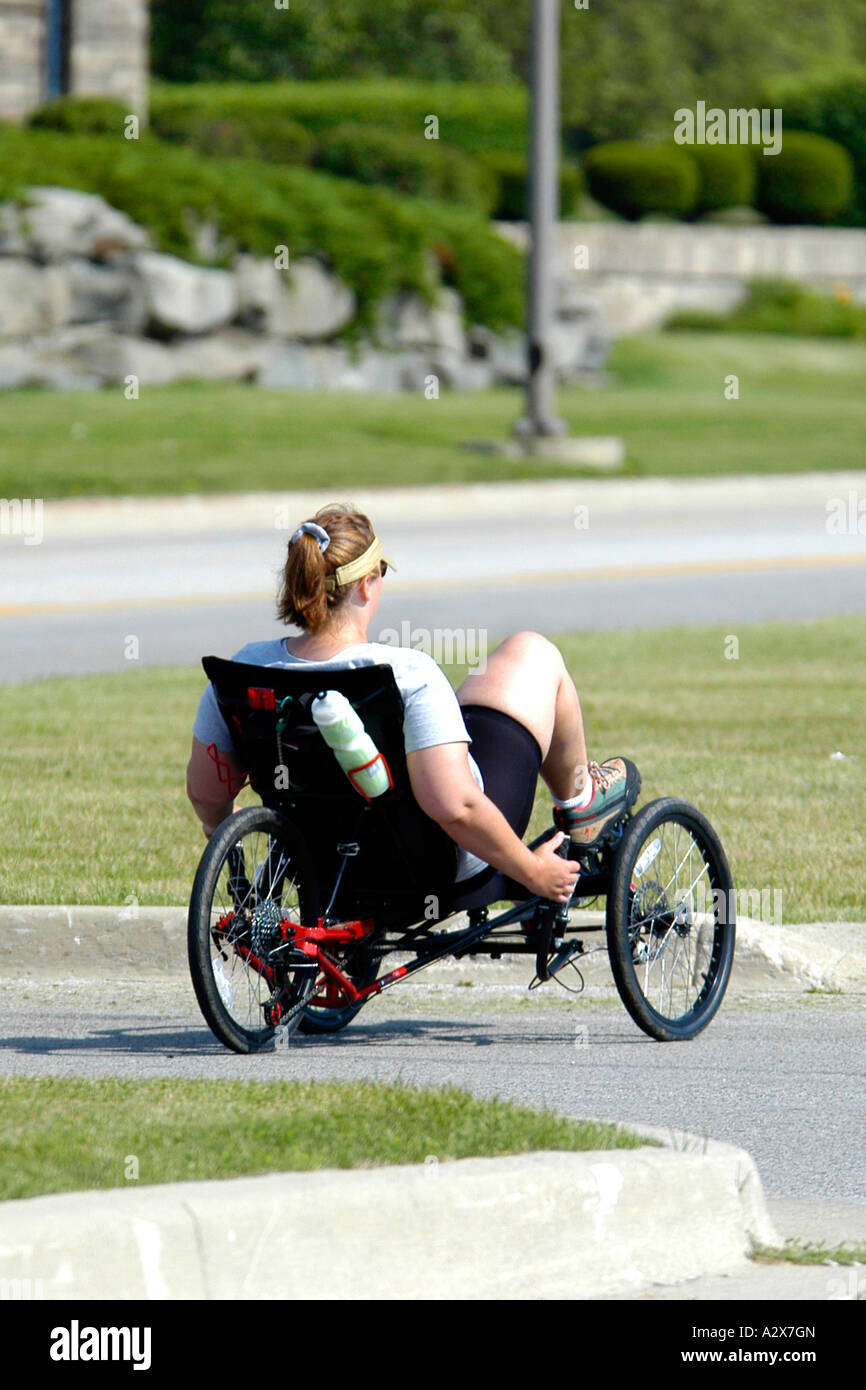 Adult female riding a three wheeled recumbent cycle Stock Photo - Alamy