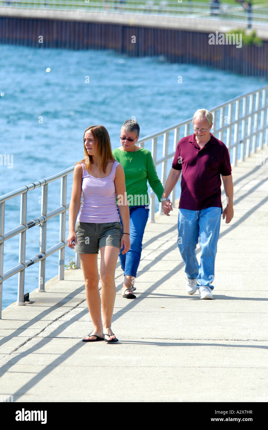People walking along the waterfront enjoying the sunshine Stock Photo ...