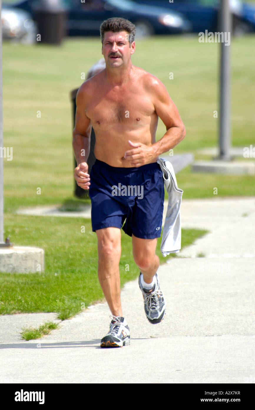 An adult male jogging as part of a healthy exercise routine Stock Photo ...