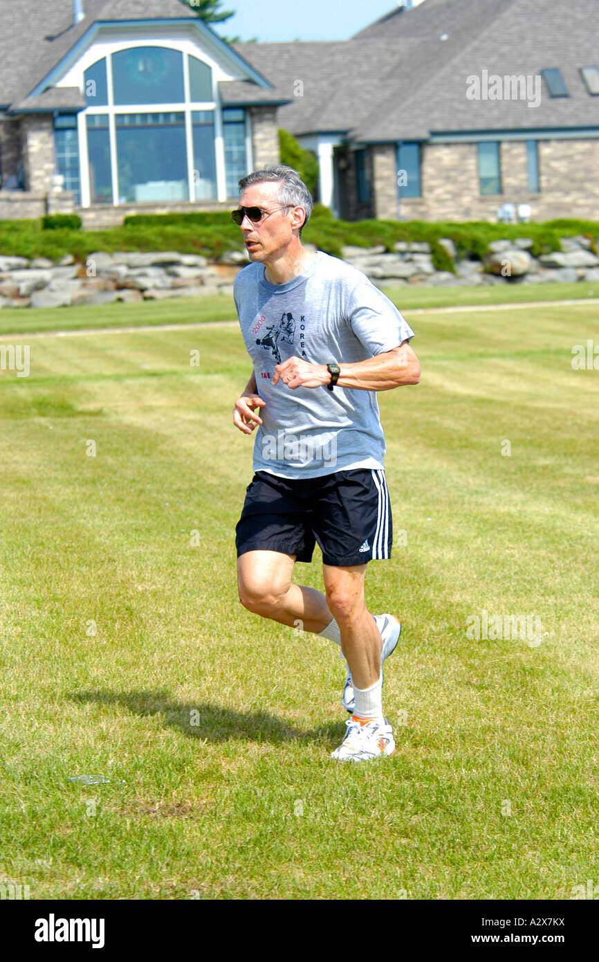 Middle aged male jogging as part of a healthy exercise routine Stock ...