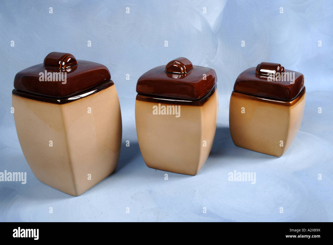 Three Stoneware Storage Jars against a blue background Stock Photo - Alamy