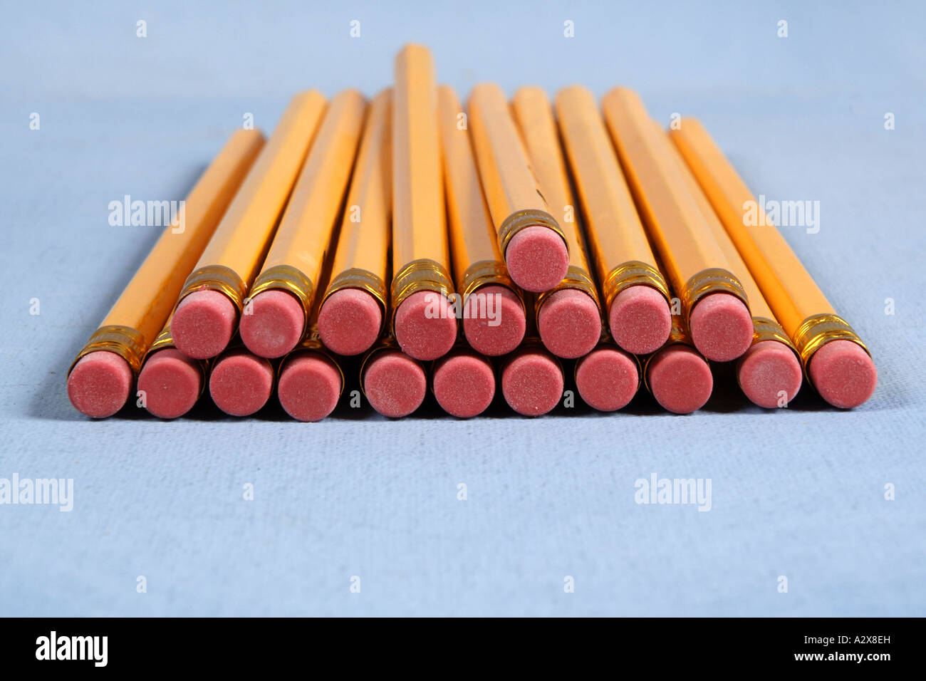 Group of Yellow Pencils with Erasers against a blue background Stock ...