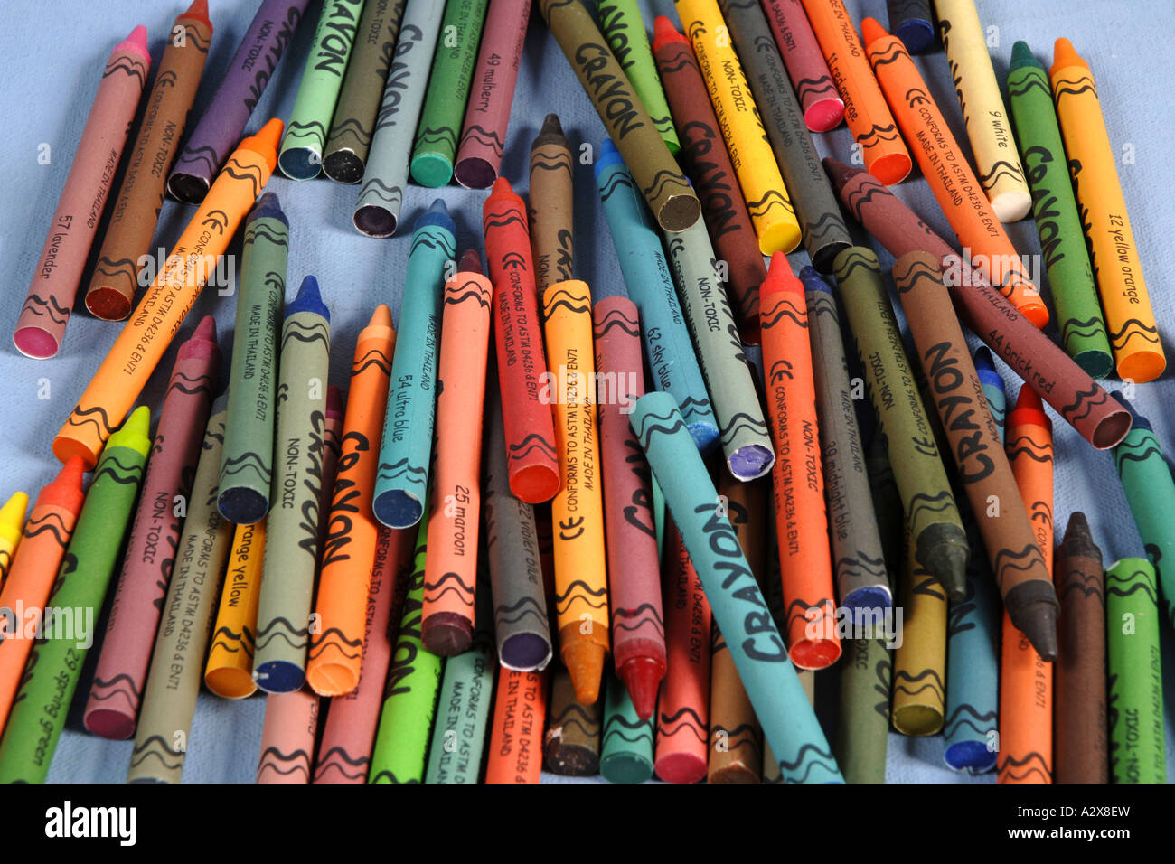 Collection of multi colored Wax Crayons against a blue background Stock ...