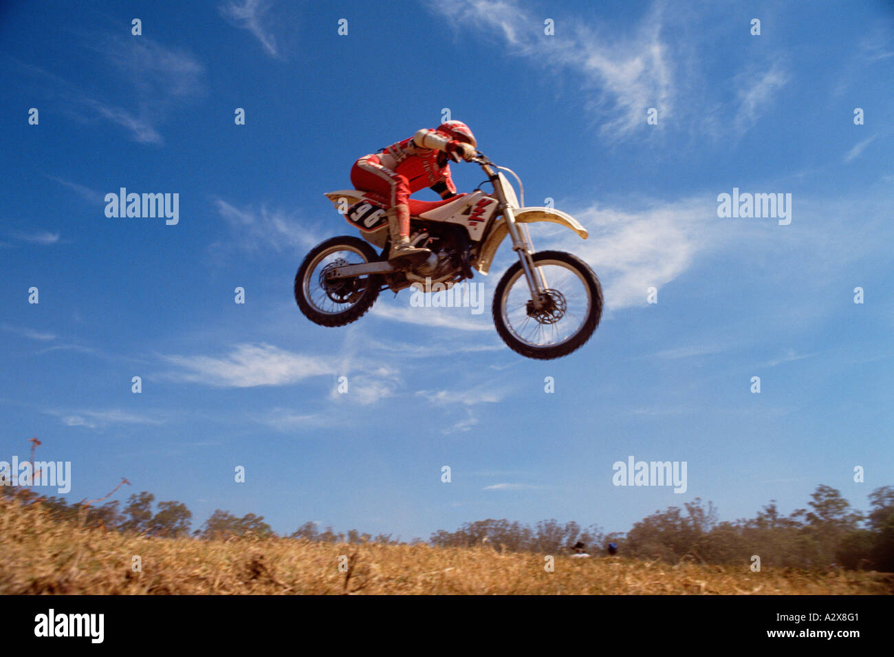 Motocross motorcycle rider in mid-air leap Stock Photo - Alamy
