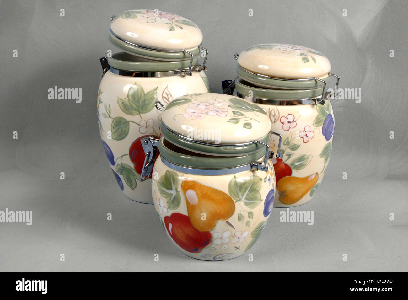 Three fancy handpainted glazed Storage Jars against a grey background ...