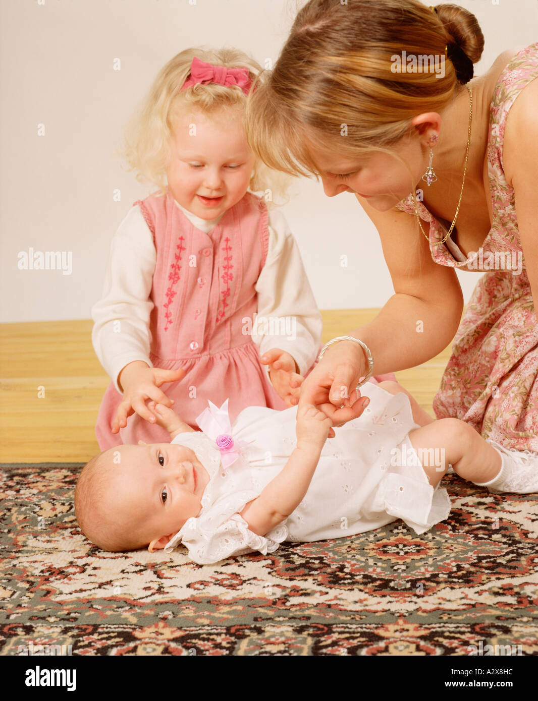 Mother and children indoors Stock Photo - Alamy