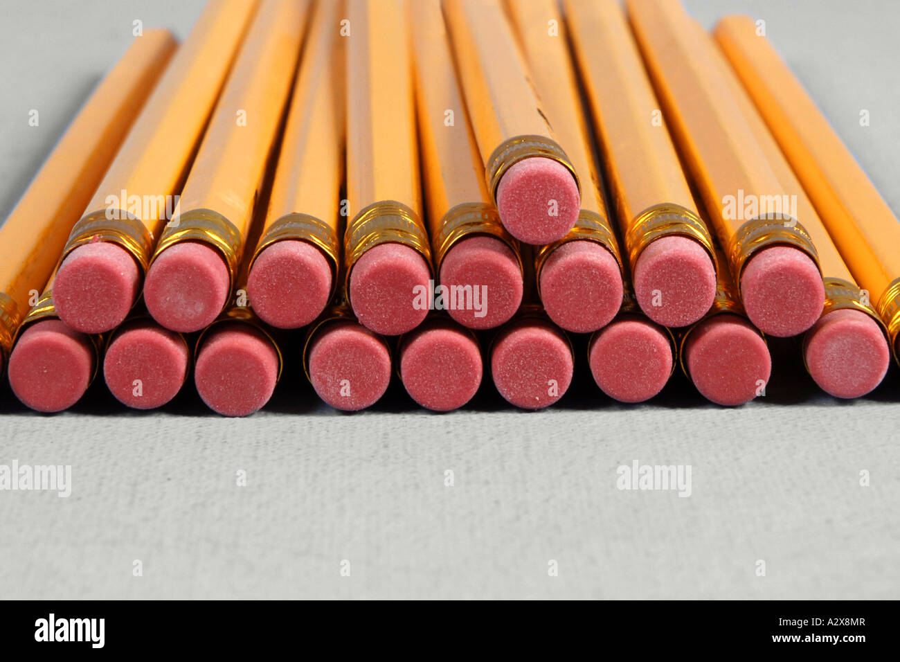 Group of Yellow Pencils with Erasers against a grey background Stock ...