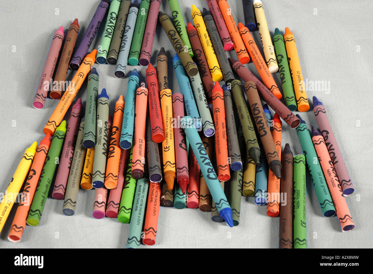 Collection of multi colored Wax Crayons against a grey background Stock ...