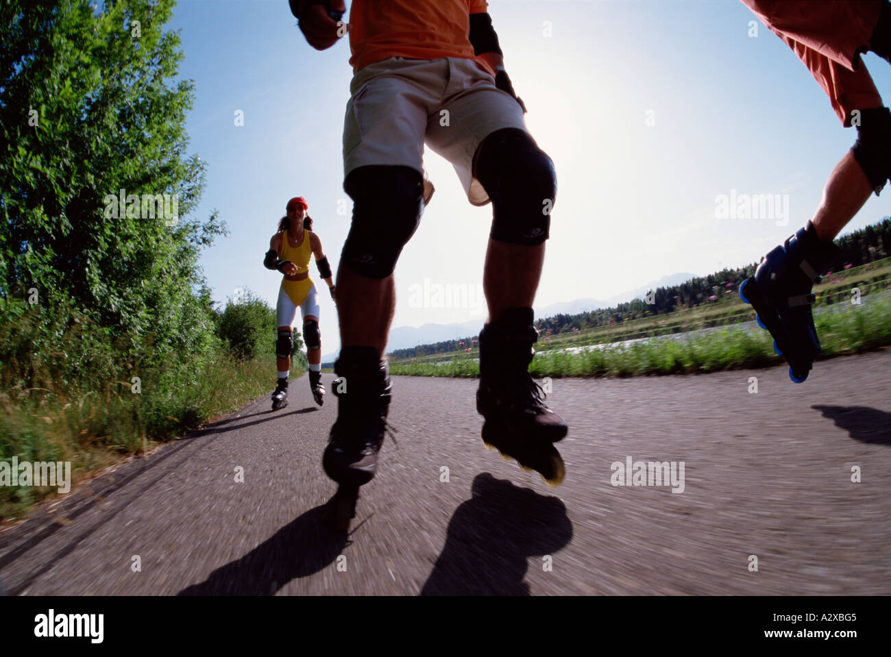 Sport. Three people rollerblading Stock Photo - Alamy