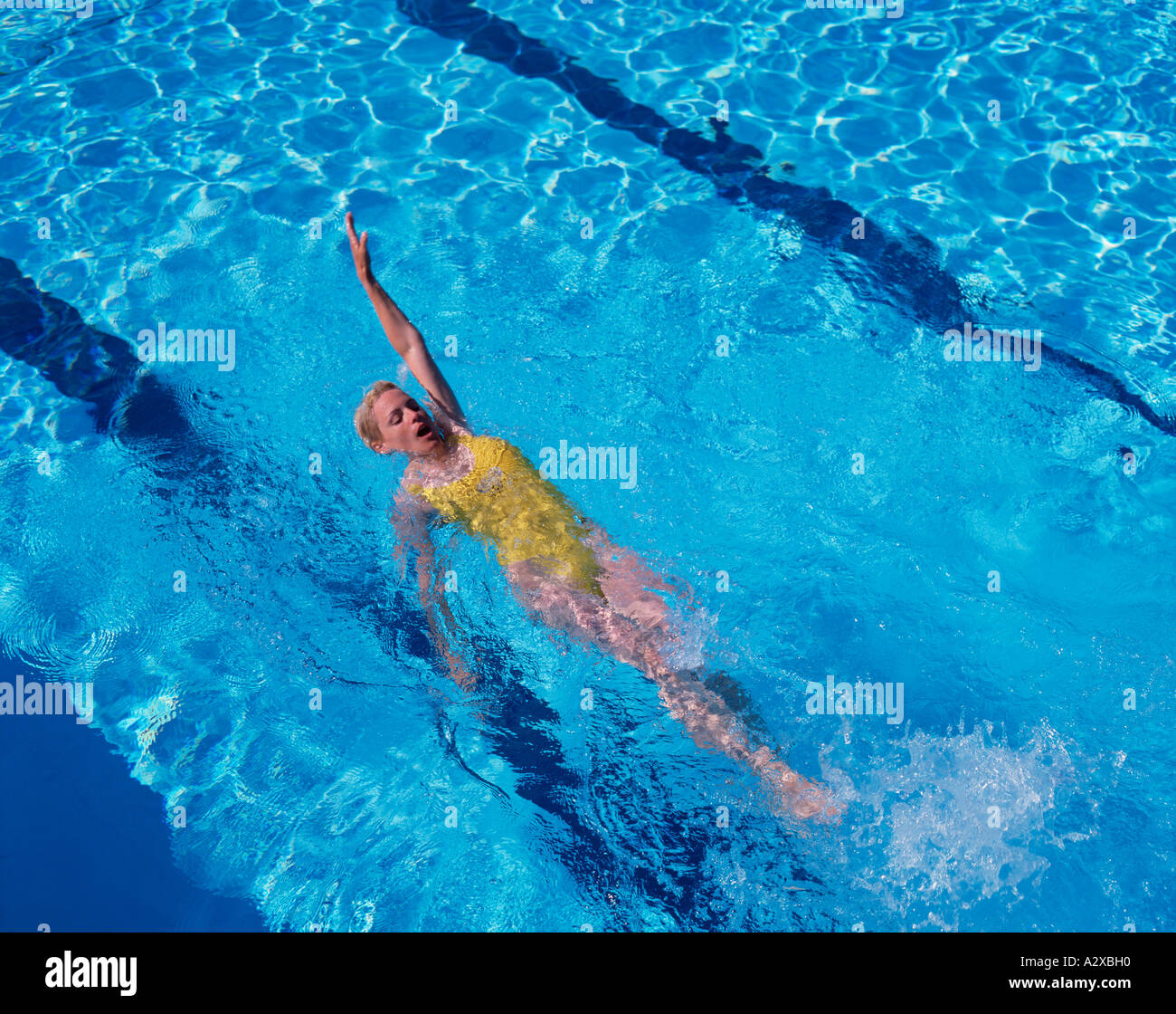 Young woman swimming backstroke in swimming pool Stock Photo - Alamy