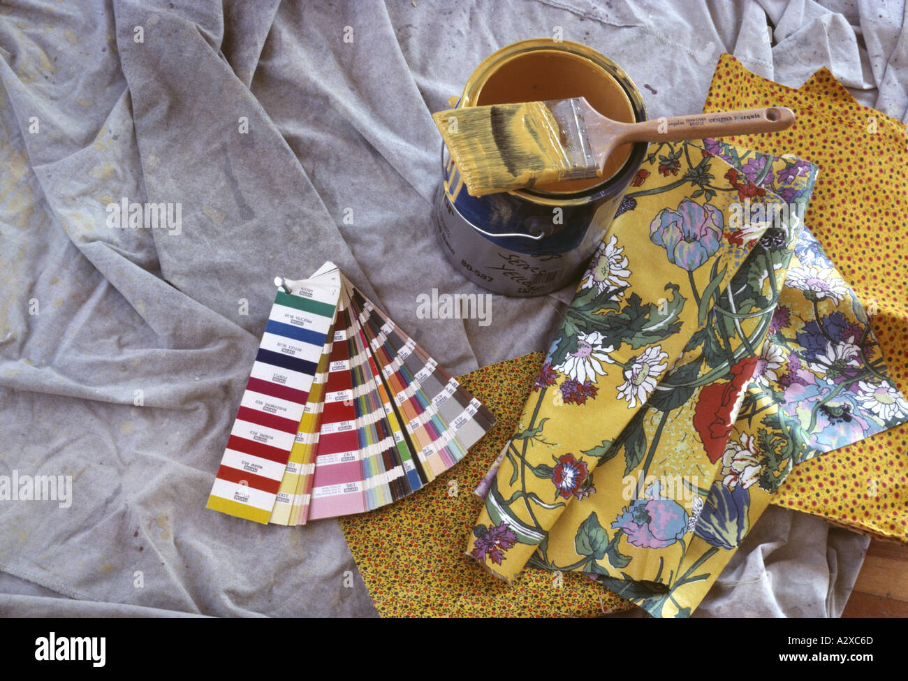 Paint, color samples and fabric samples on a gray Canvas drop cloth for ...