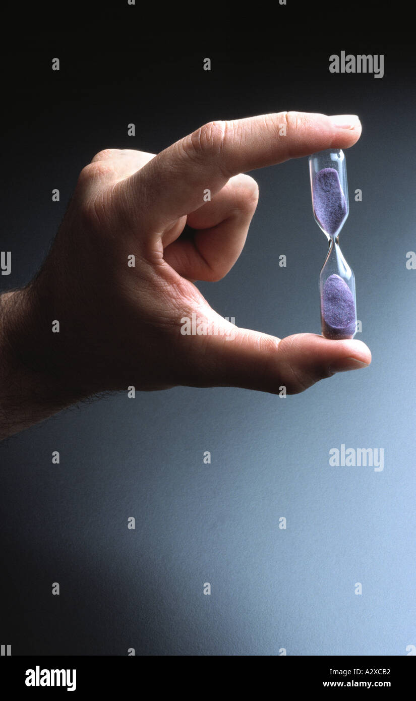 hand holding hourglass Stock Photo - Alamy