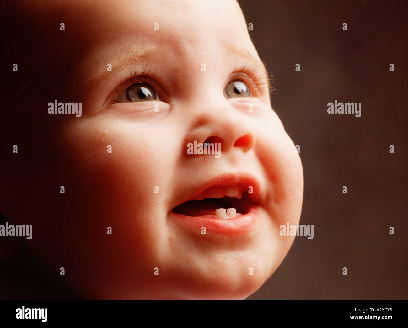 Indoor close-up of baby's smiling face Stock Photo - Alamy