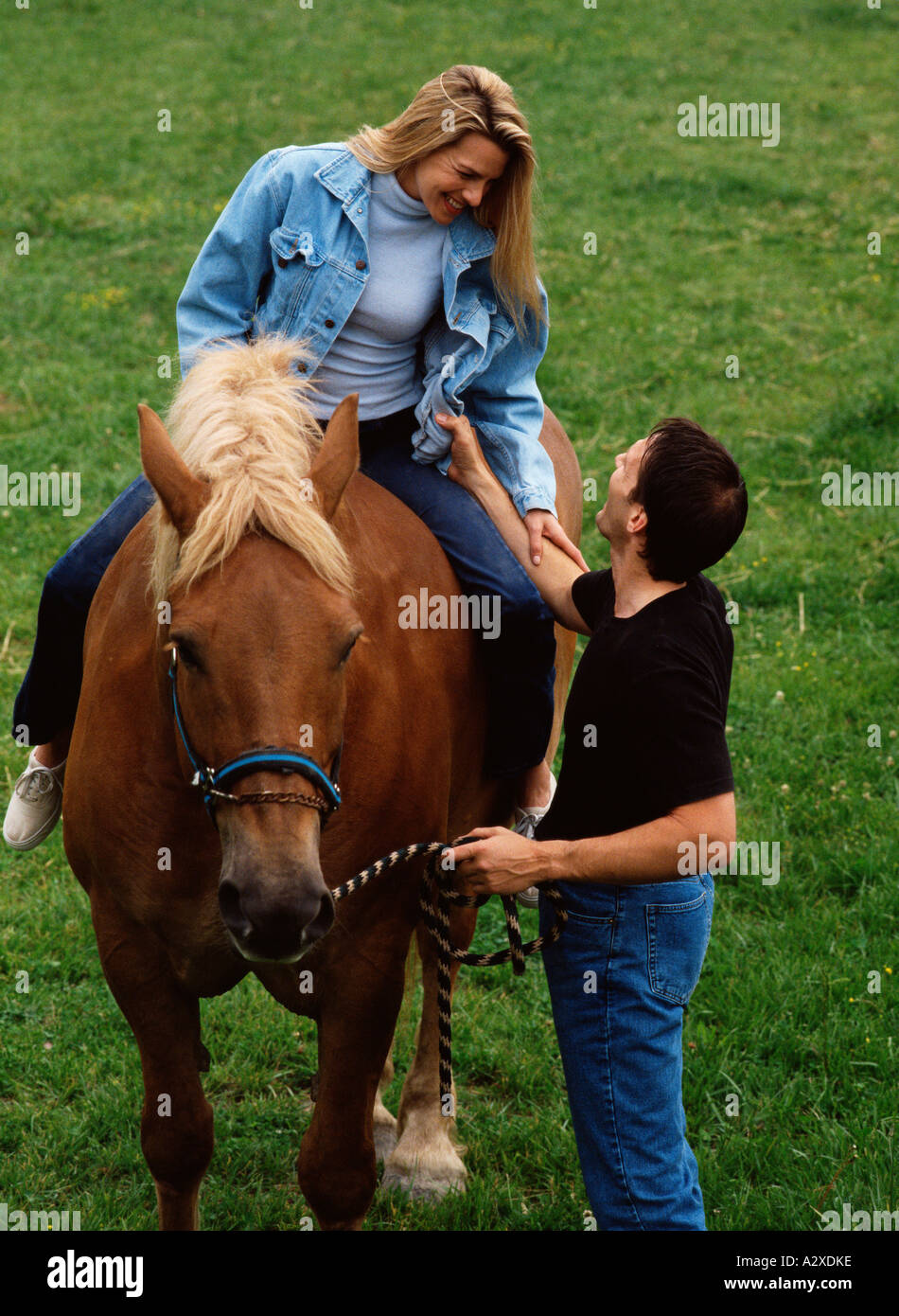 Young couple outdoors. Woman bareback horse riding Stock Photo - Alamy