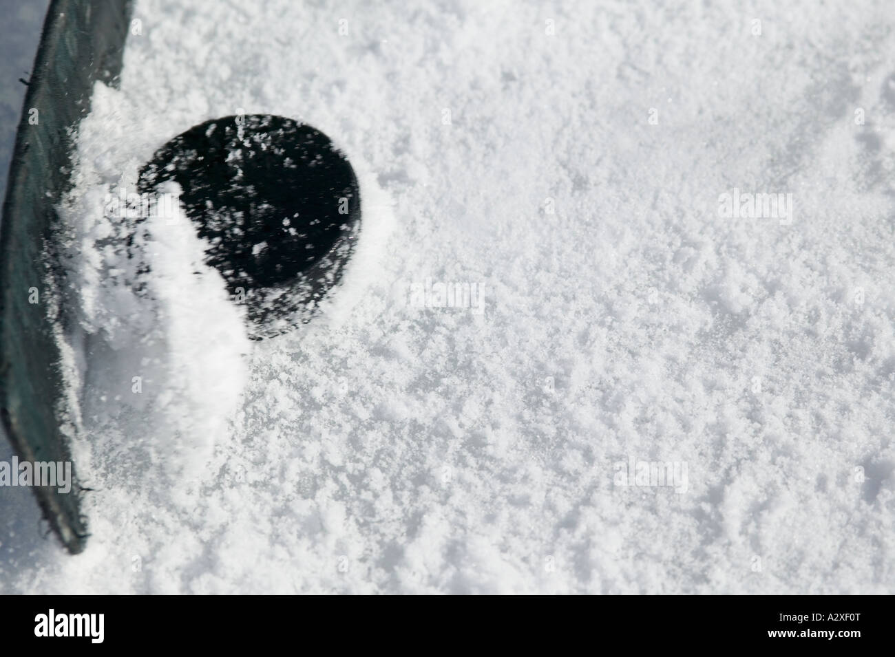 Close up of hockey stick and puck on ice Stock Photo - Alamy