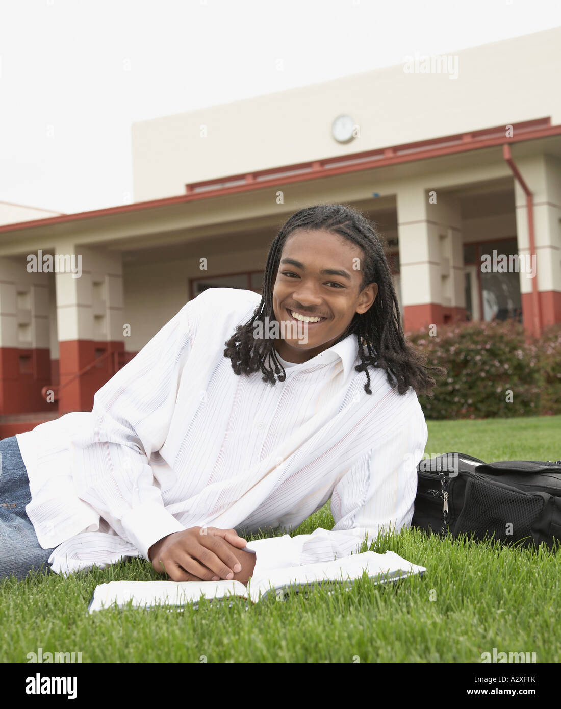 Young African man smiling on school campus Stock Photo - Alamy