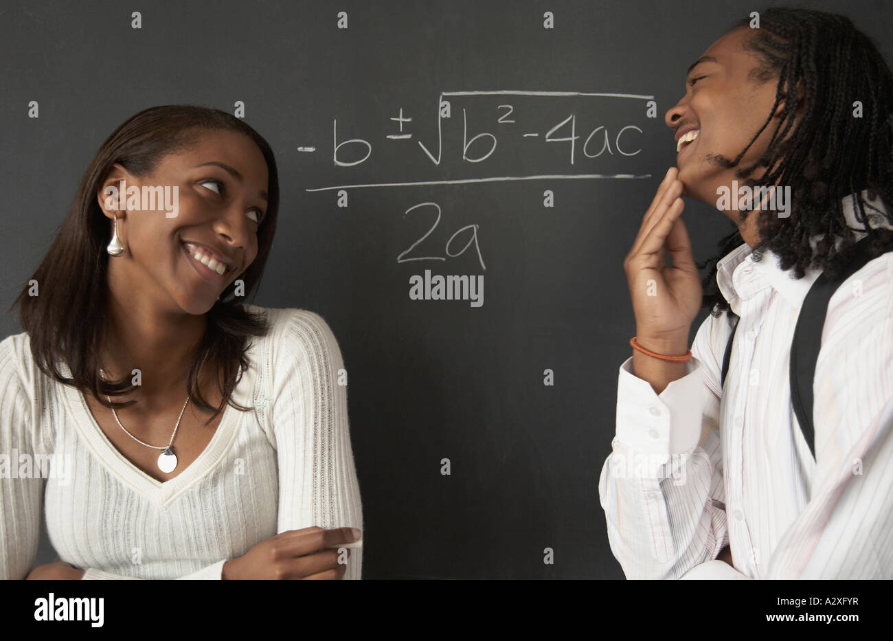 Two African students next to math problem on blackboard Stock Photo - Alamy