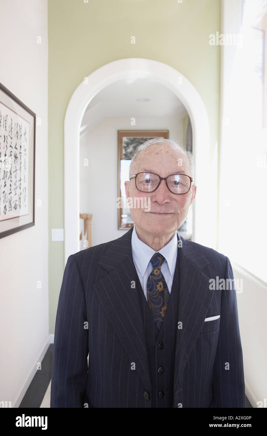 Senior man wearing suit in hallway Stock Photo - Alamy