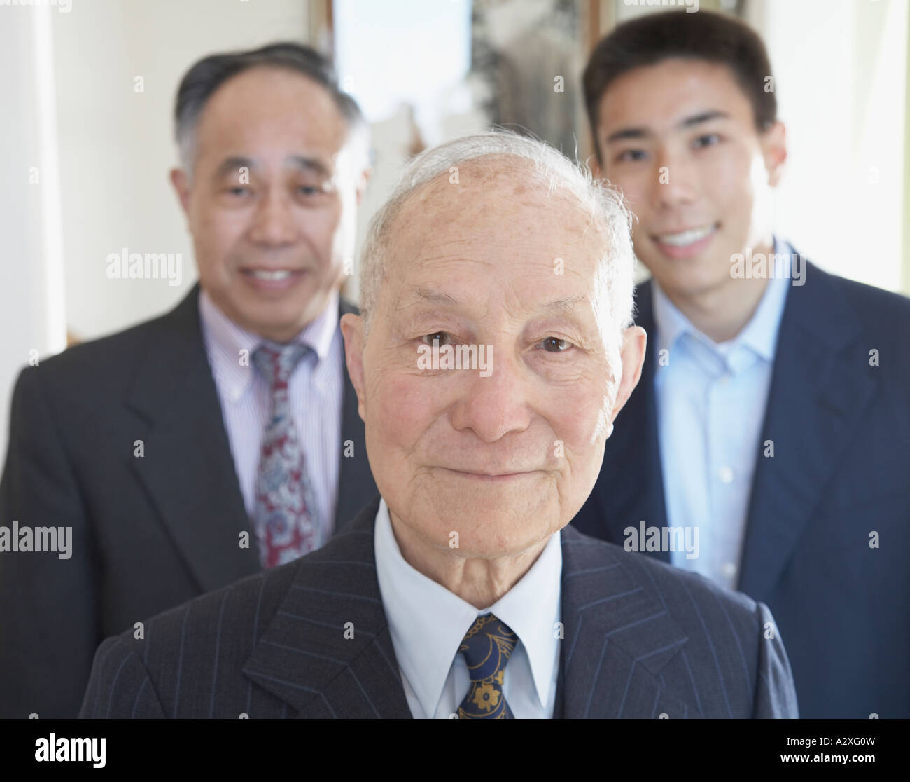 Senior Asian man with family members in background Stock Photo - Alamy