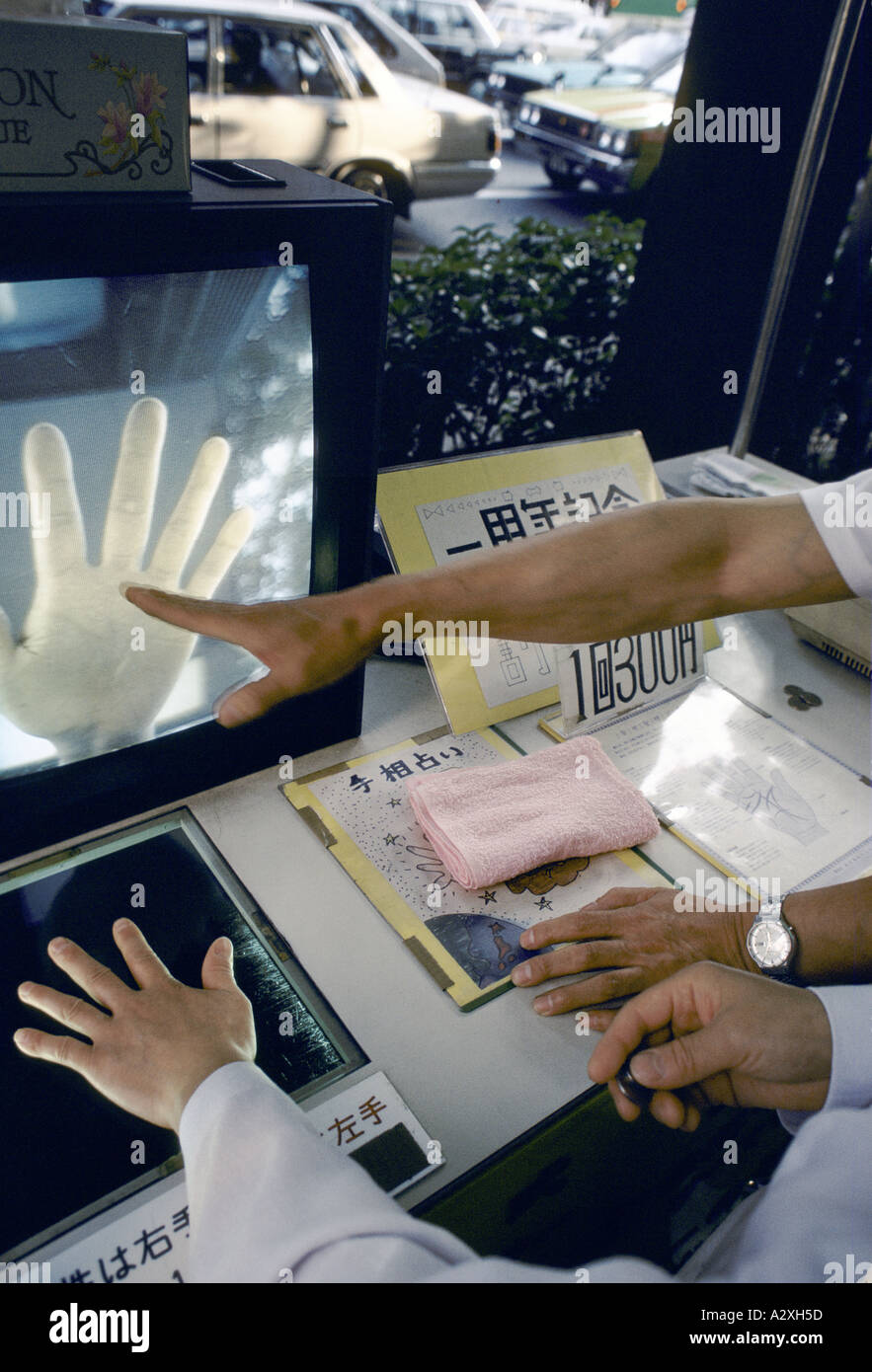 tokyo japan a customer has his palm read by a computer palm reader on ...