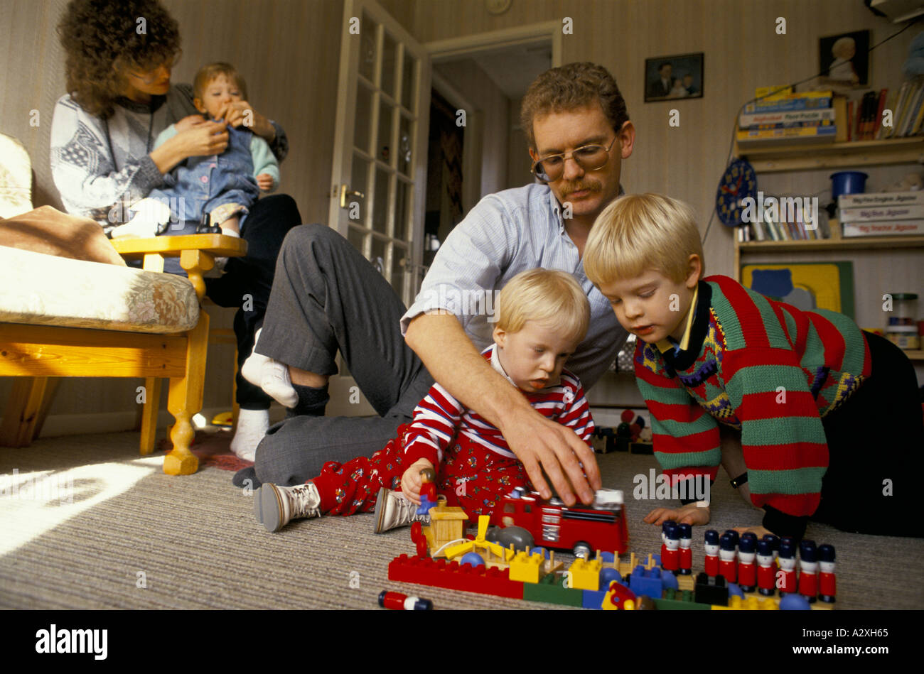 Unemployed man at home playing with his children, UK Stock Photo - Alamy