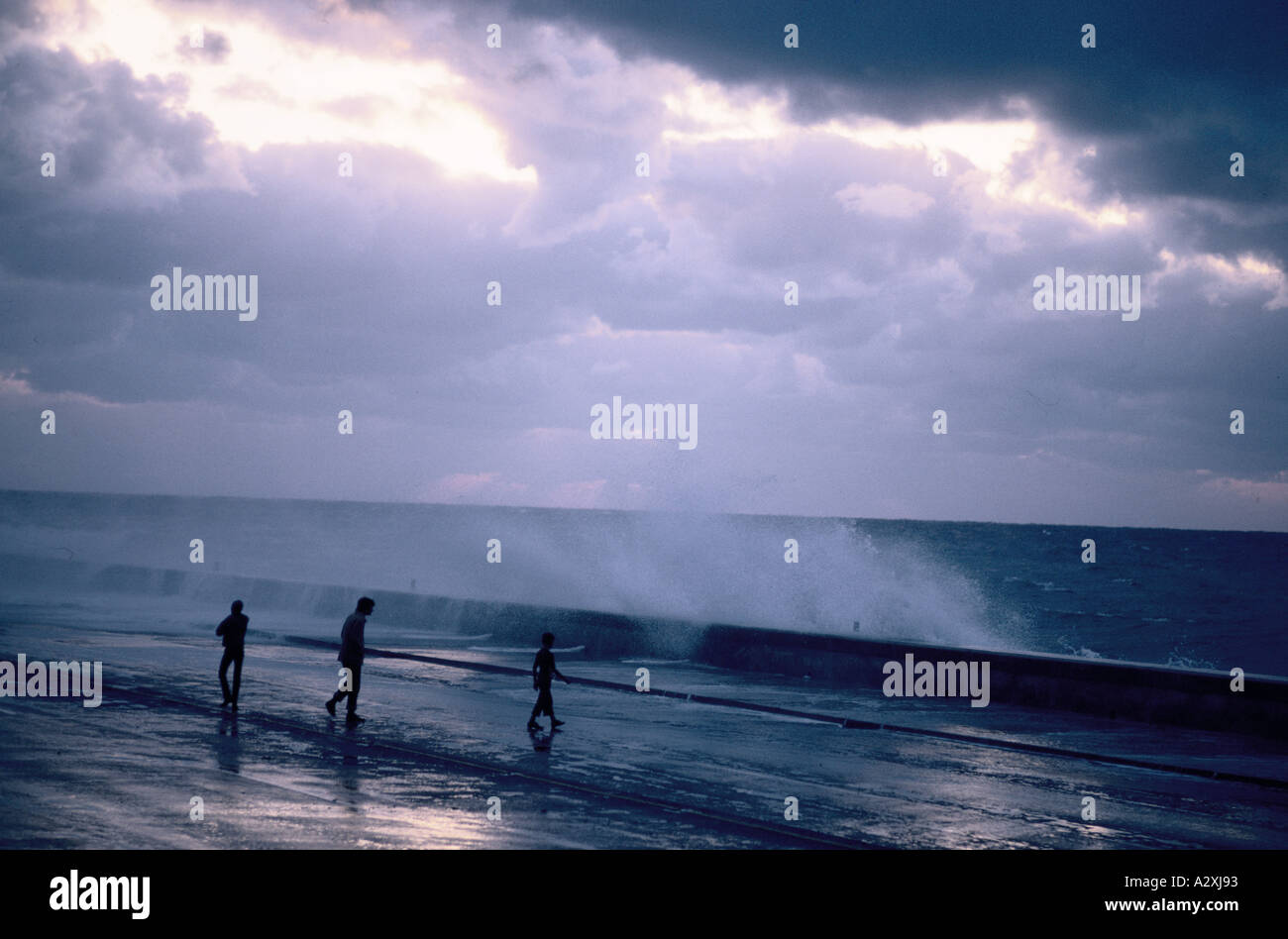 Waves crashing man in ocean sunset hi-res stock photography and images ...