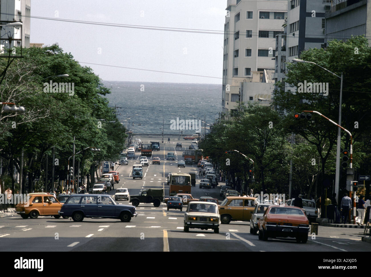 Street scene in Havana, Cuba, with traffic on a road leading down to ...