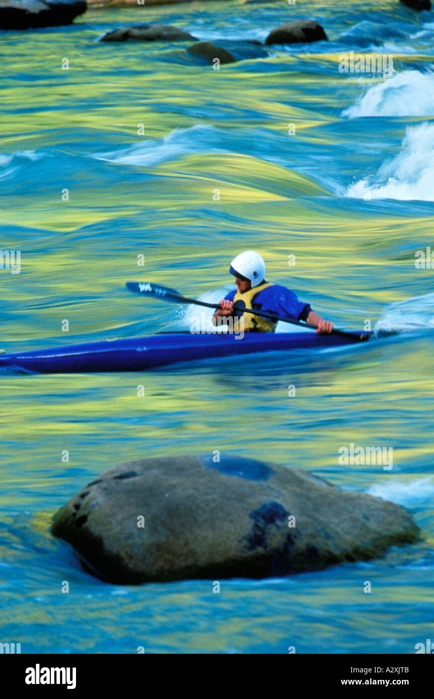 CHILE Kayaker paddling through silky yellow and blue water BIO BIO ...