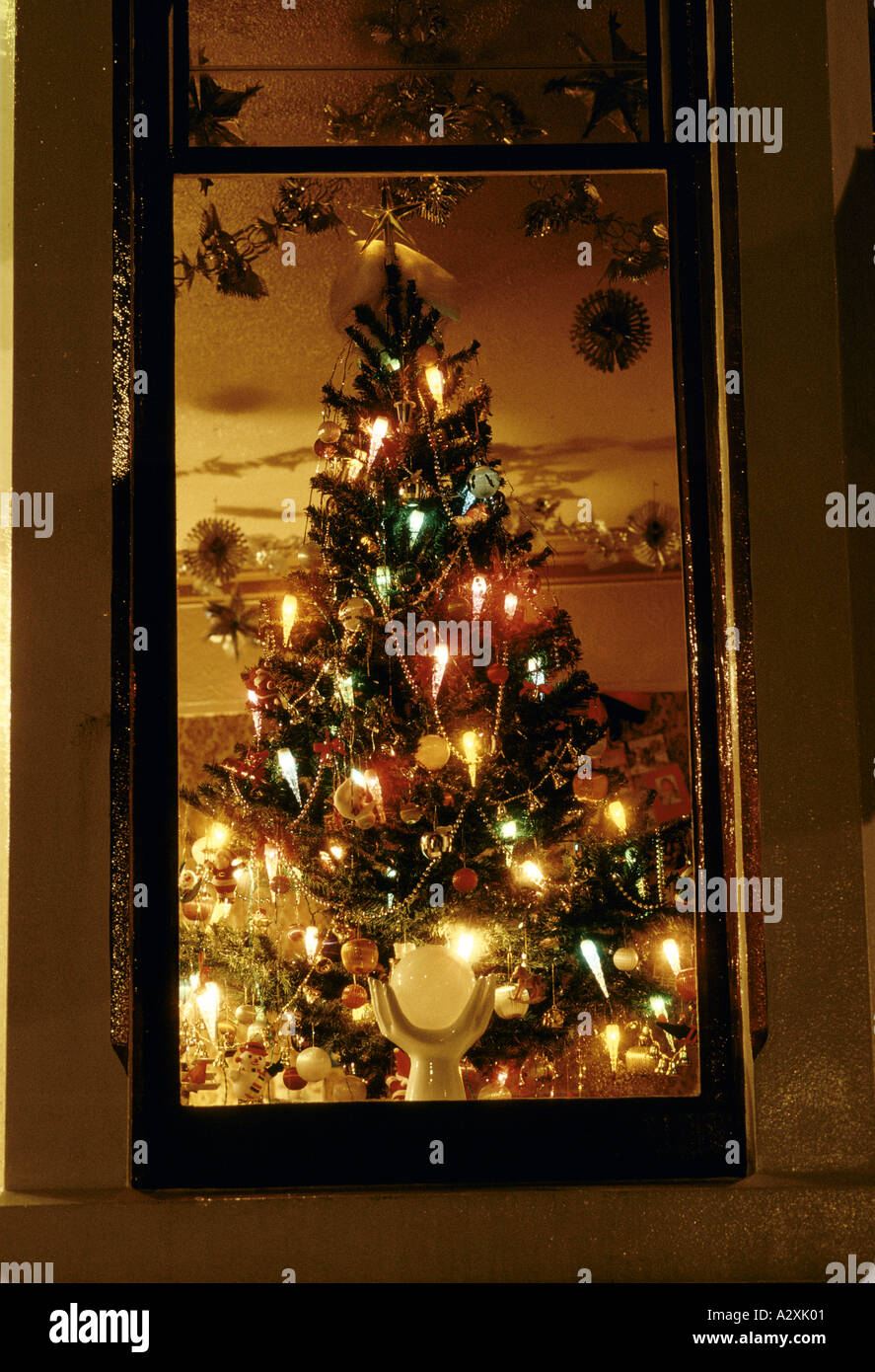 christmas tree displayed in window blackpool Stock Photo - Alamy