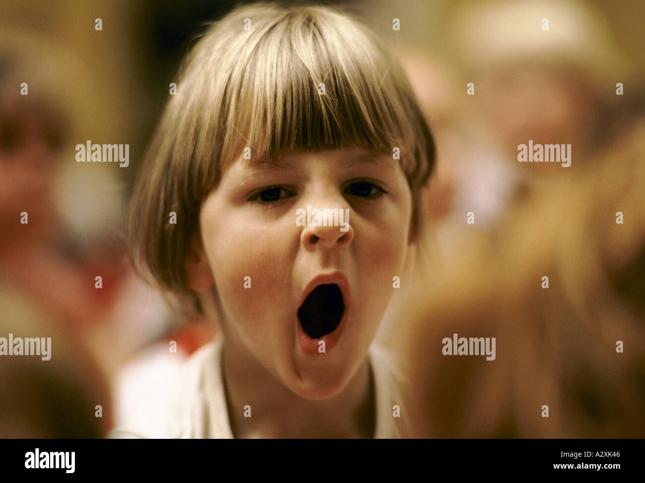 young girl at school yawning Stock Photo - Alamy