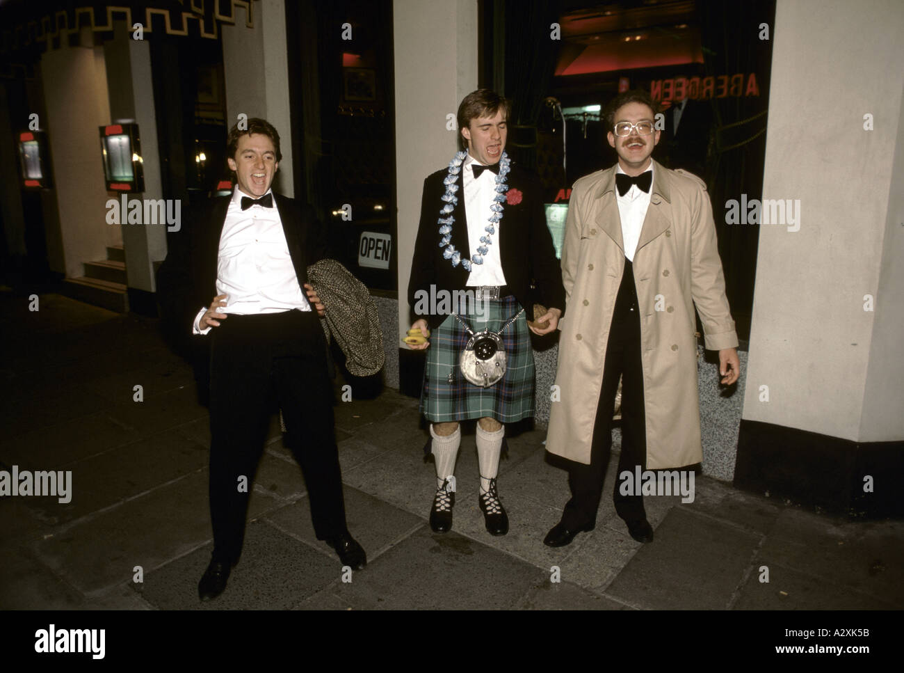 men in street at night time Stock Photo - Alamy