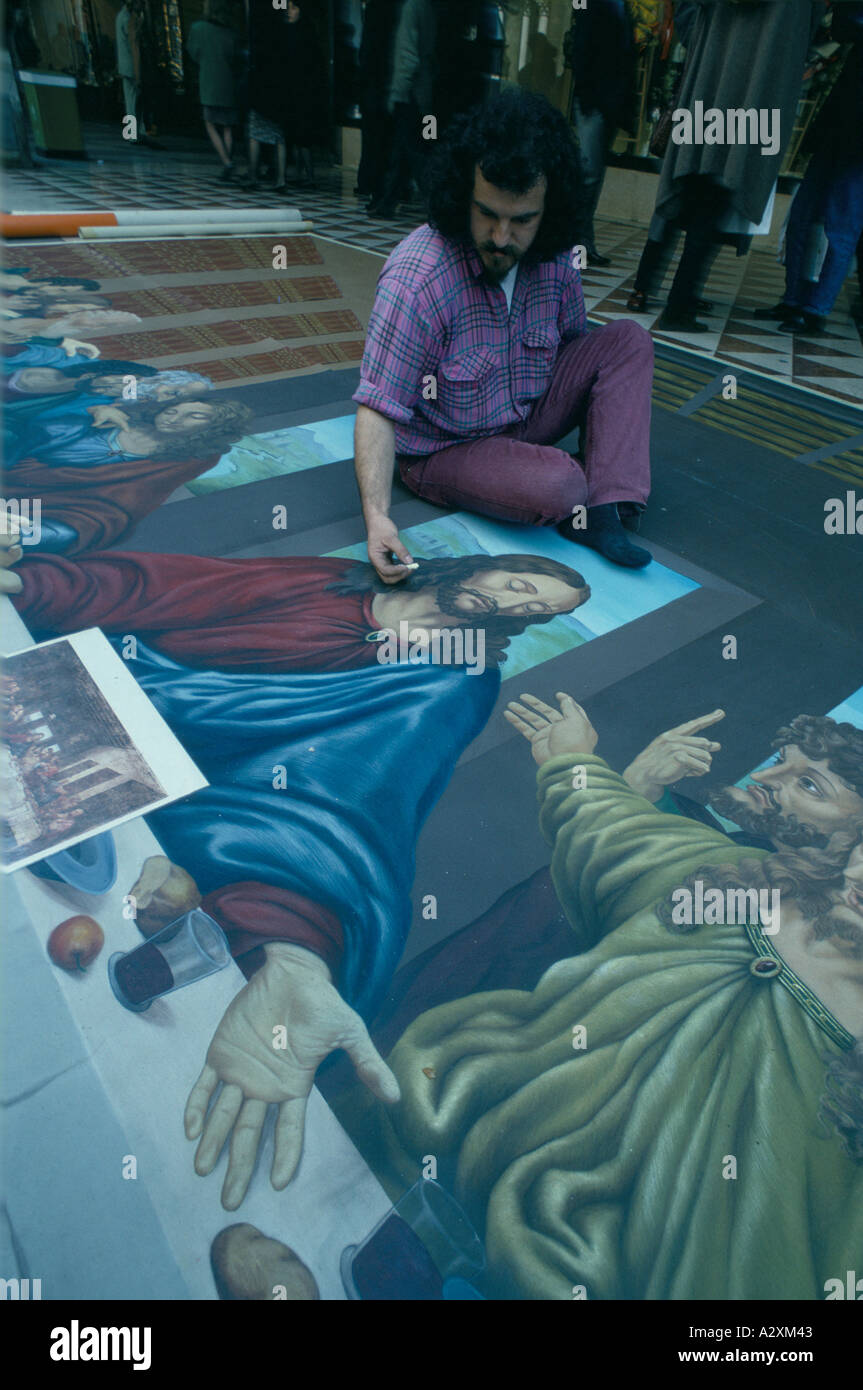 a pavement chalk artist puts the finishing touches on jesus s hair in a ...