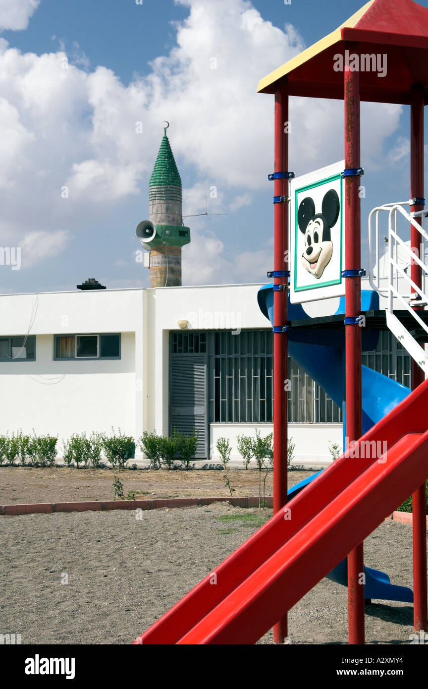 Mickey Mouse playground structure and roadside mosque minaret in rural ...