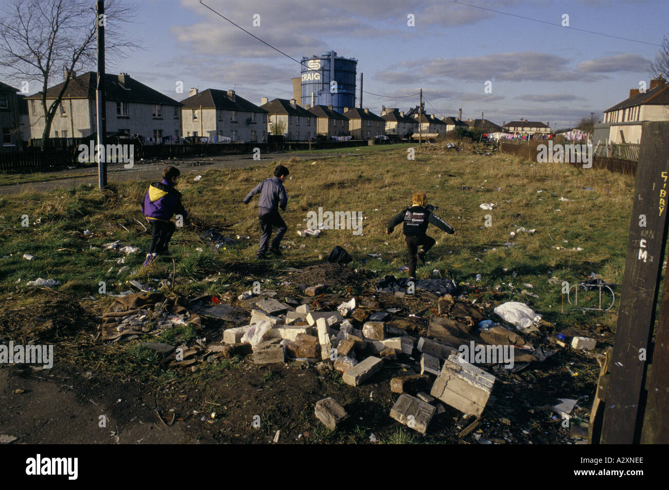 Motherwell, Scotland. Boys play on wasteland. Behind them Ravenscraig ...