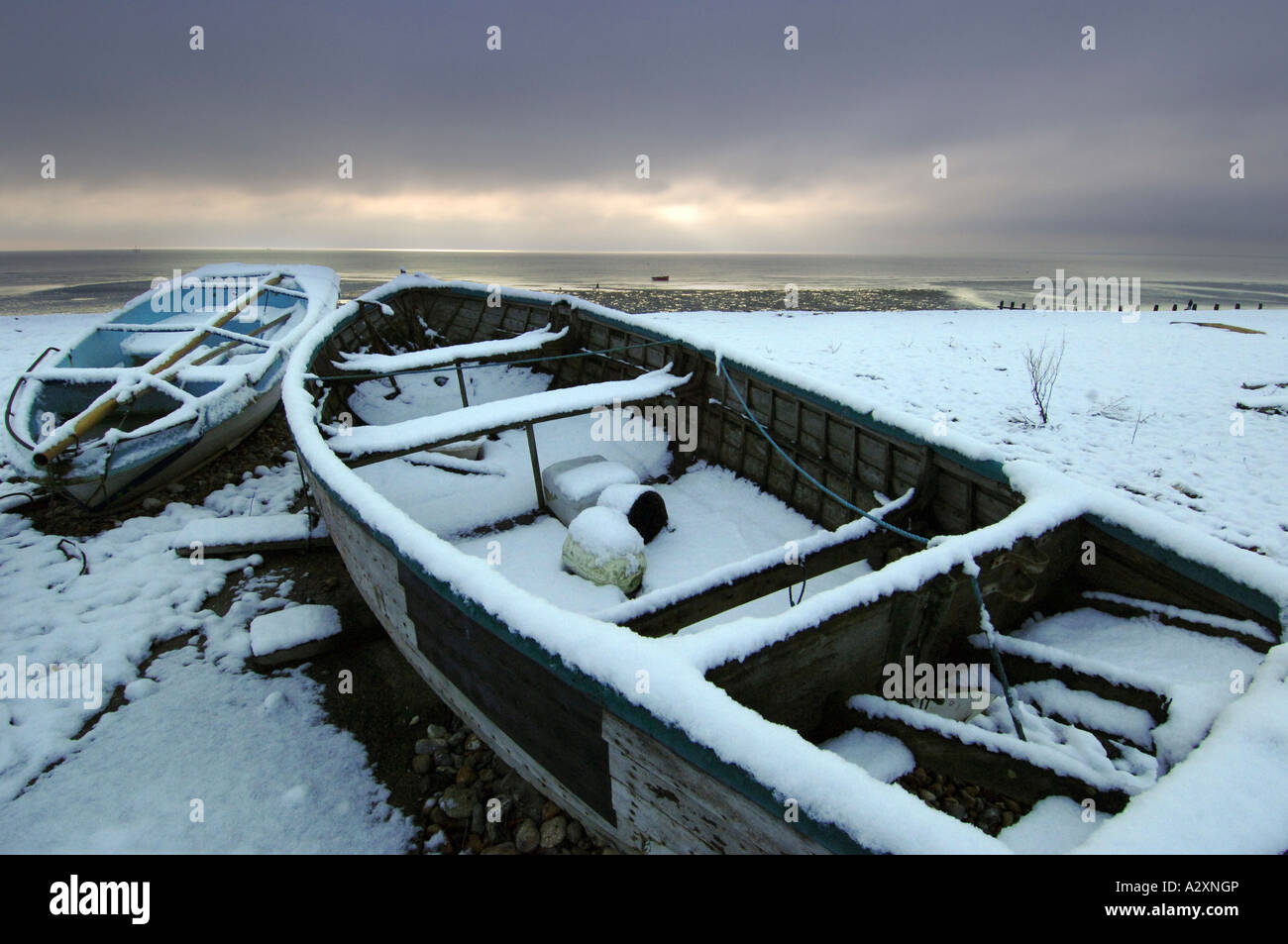 Snow on two fishing boats on Worthing beach after winter storms in ...