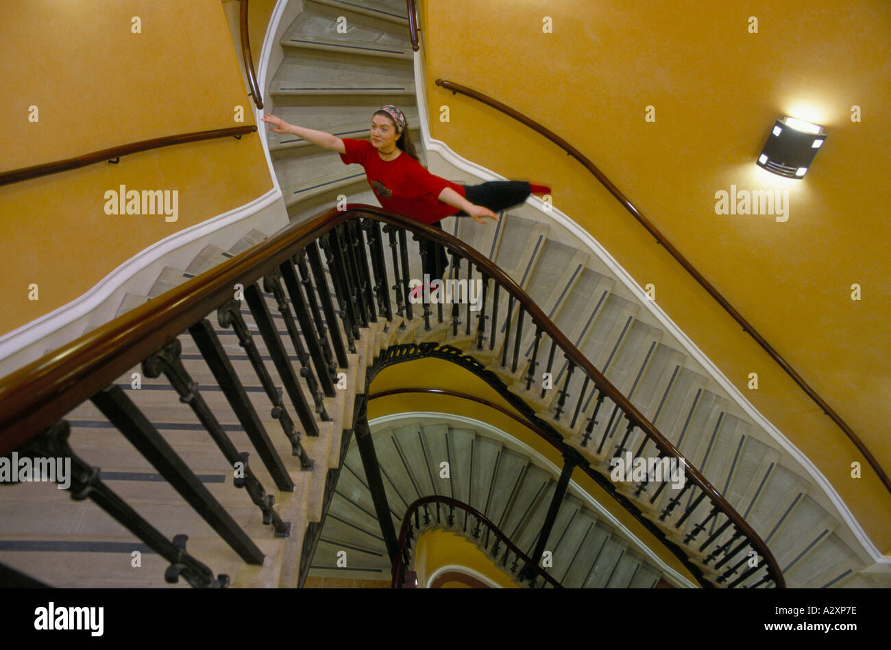 Female dance student balance on one leg with arms outstretched on the ...