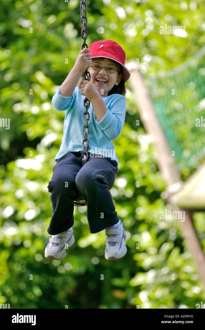 Girl enjoys flying fox rope slide Stock Photo - Alamy