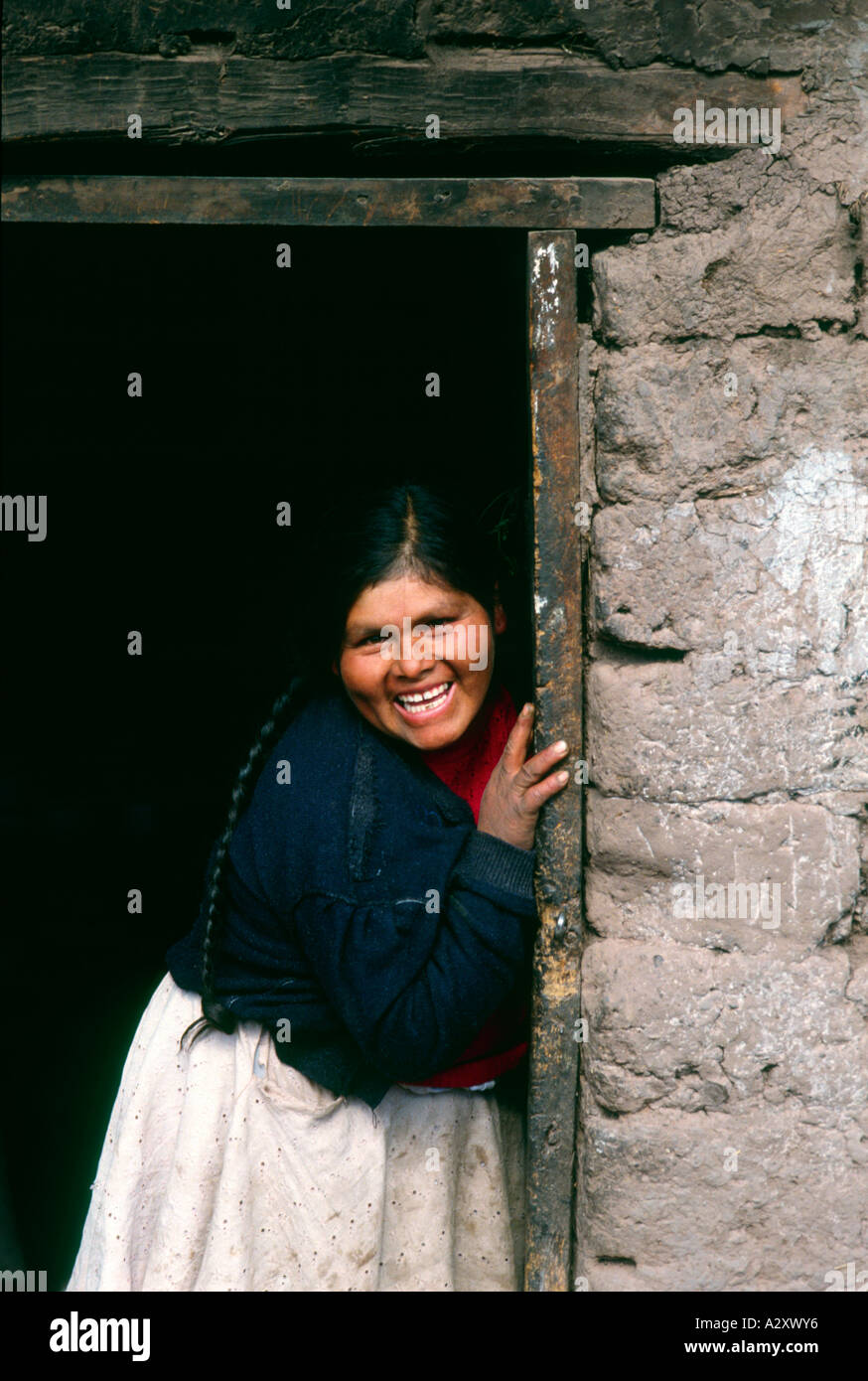 A young indigenous Peruvian woman smiling in her doorway Stock Photo ...