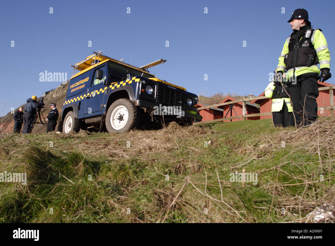 Police and Coastguard officers working together teamwork at Branscombe ...