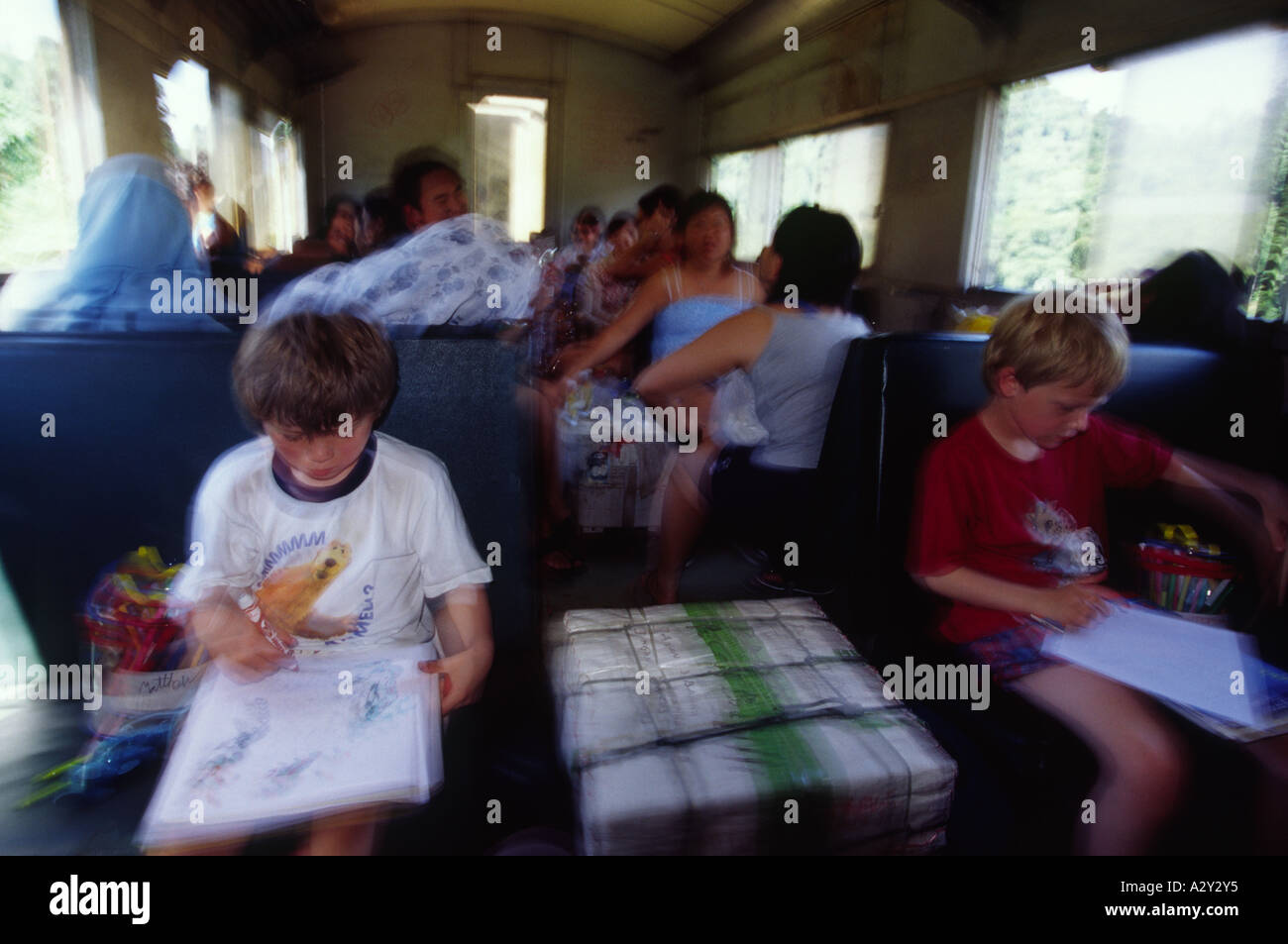 Horizontal image of two boys travelling on Tenom train in Borneo with ...