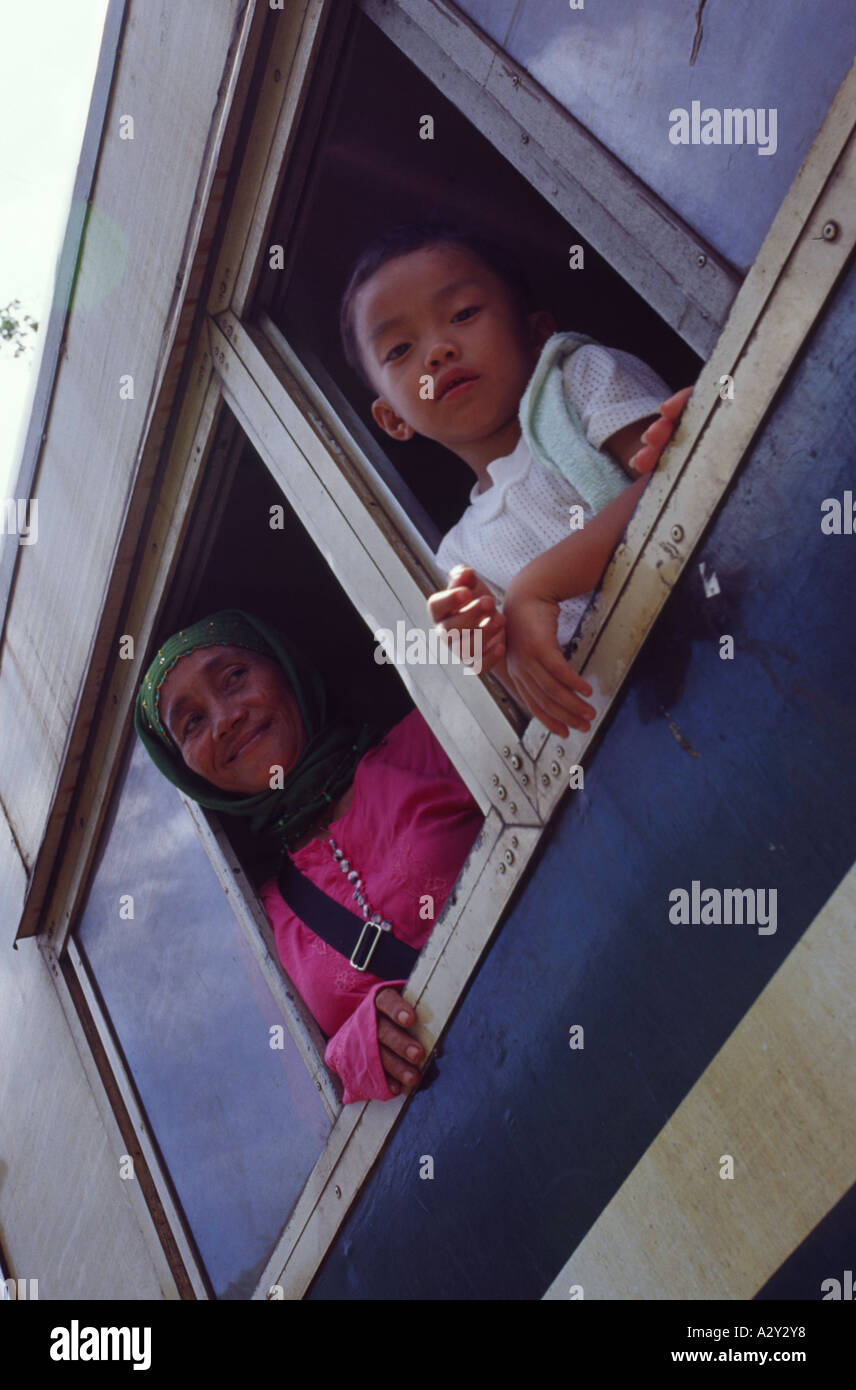 Passengers look out of the window of the Tenom train, Borneo's only ...