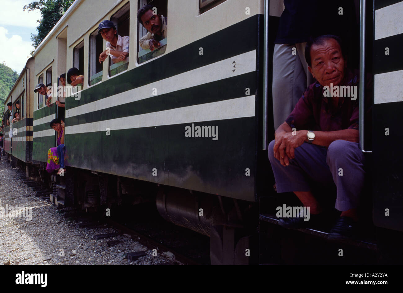 Passengers sit on steps to wait as the Tenom train, the only train in ...