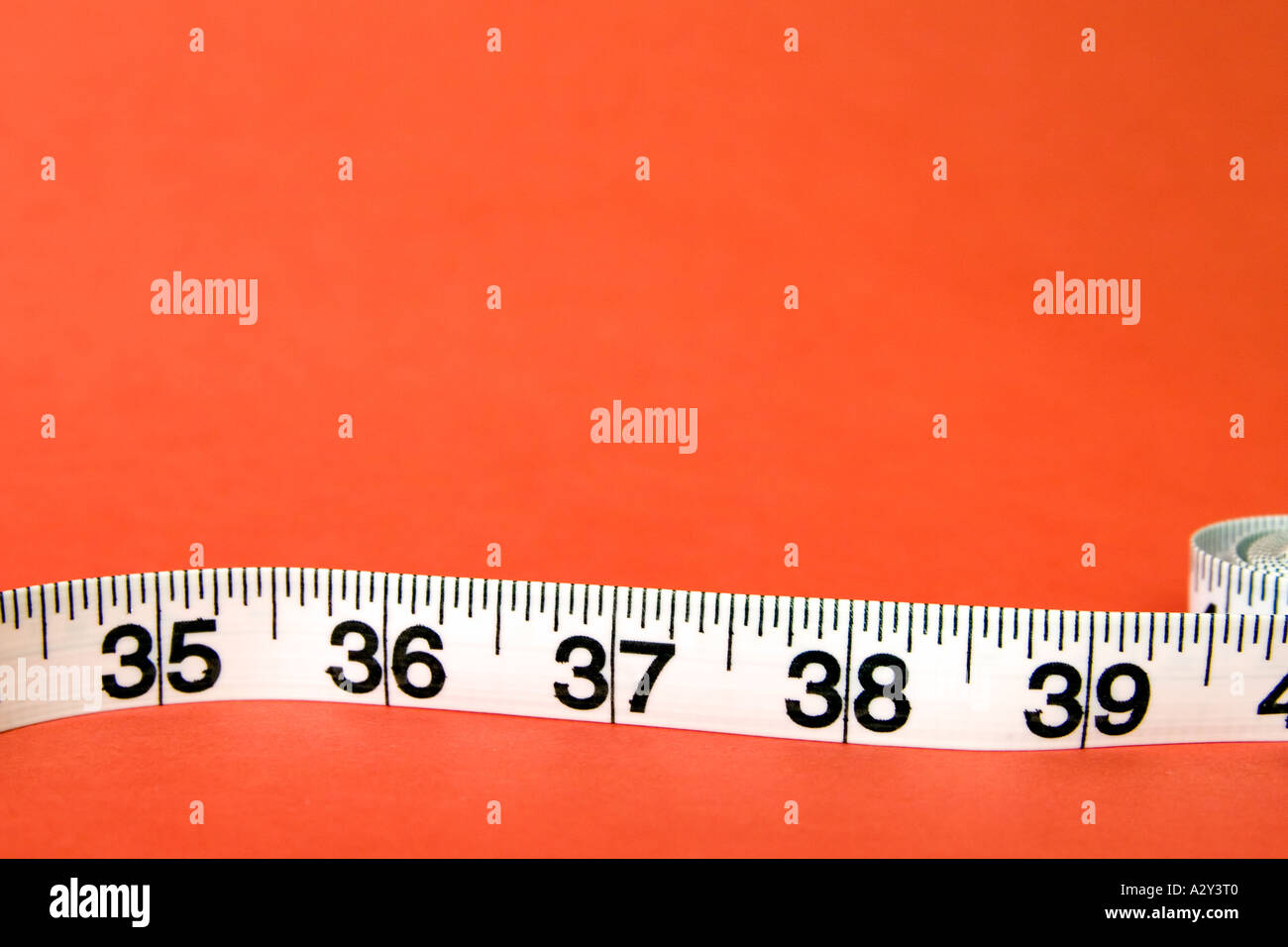 Measuring Tape red background with common mens waste sizes Stock Photo ...