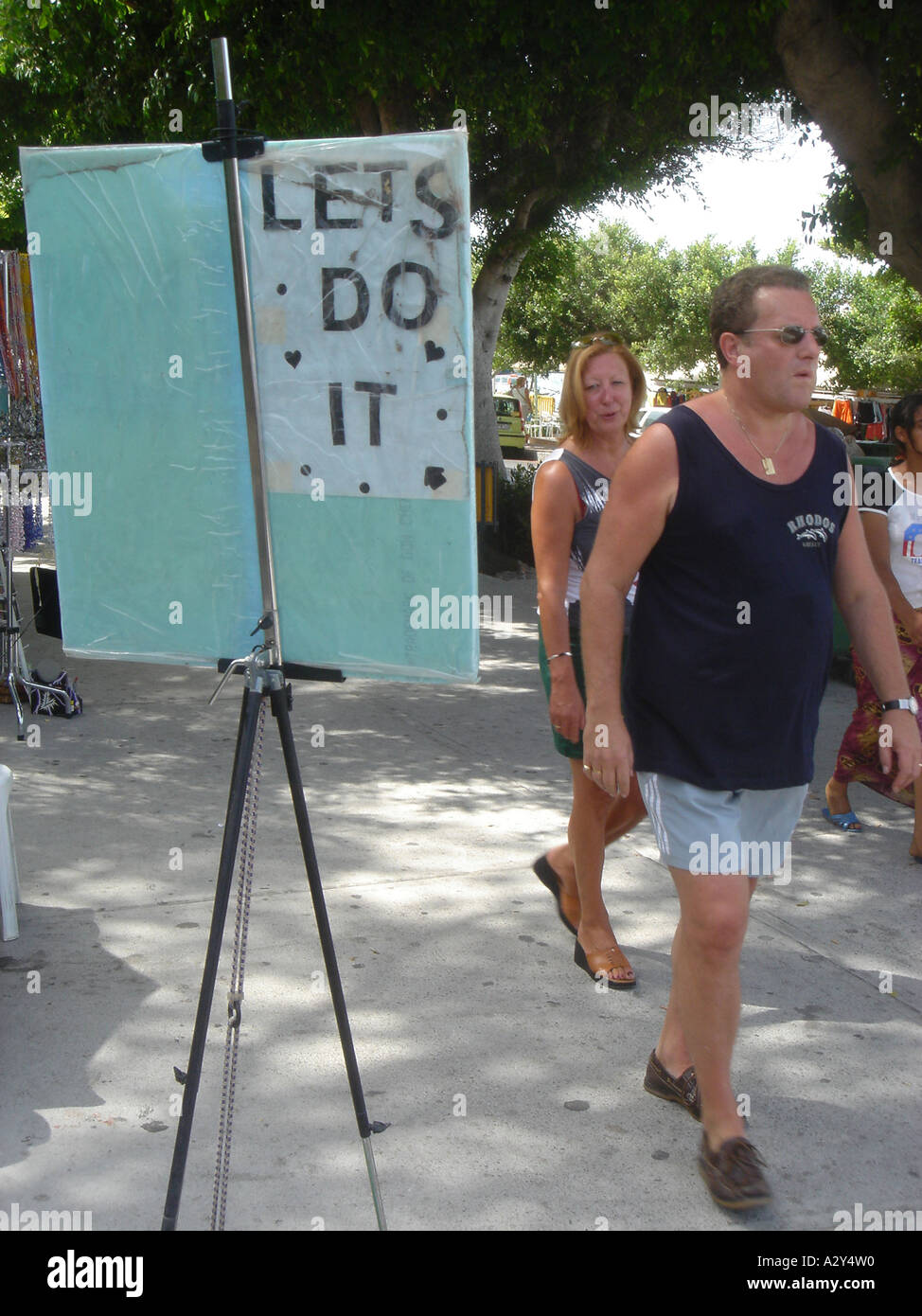 Man walking past sign, Rhodes Town, Rhodes, Greece, July 2005 Stock ...