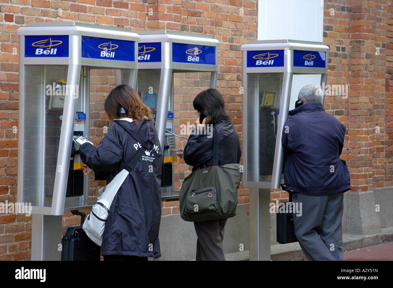 People using a pay telephone outside Stock Photo - Alamy