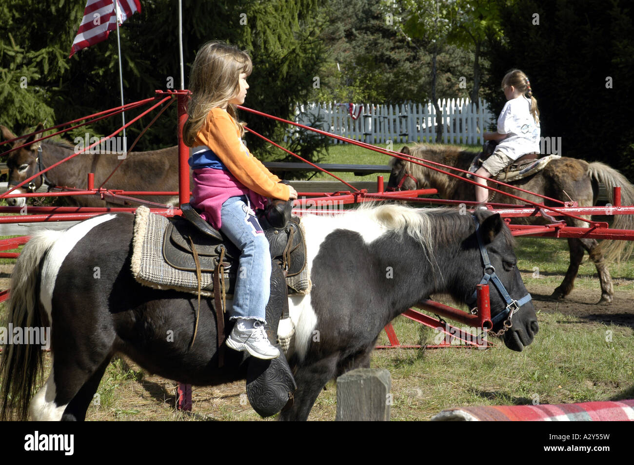 Child riding on a pony for fun and pleasure Stock Photo - Alamy