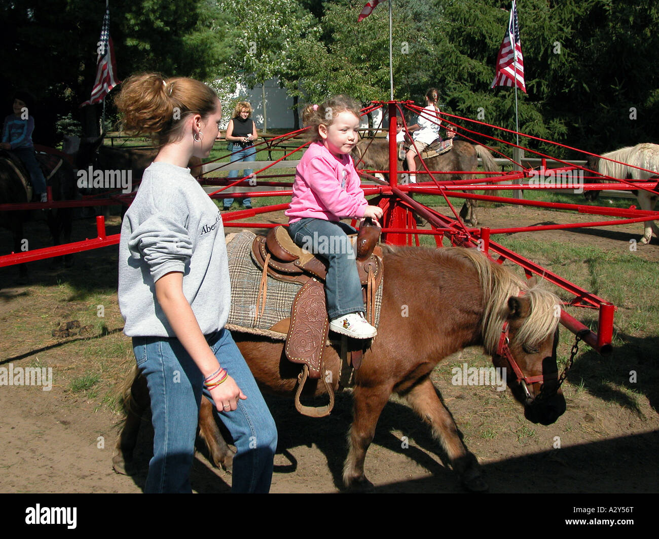 Child riding on a pony for fun and pleasure Stock Photo - Alamy