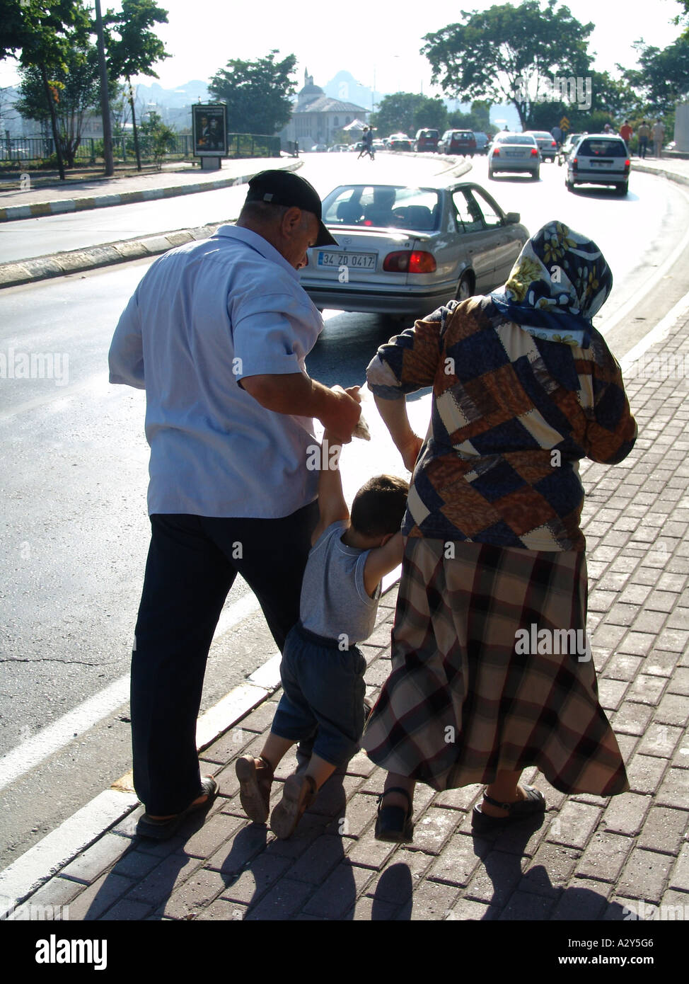 Man and woman dragging child, near Galata Bridge, Istanbul, Turkey ...